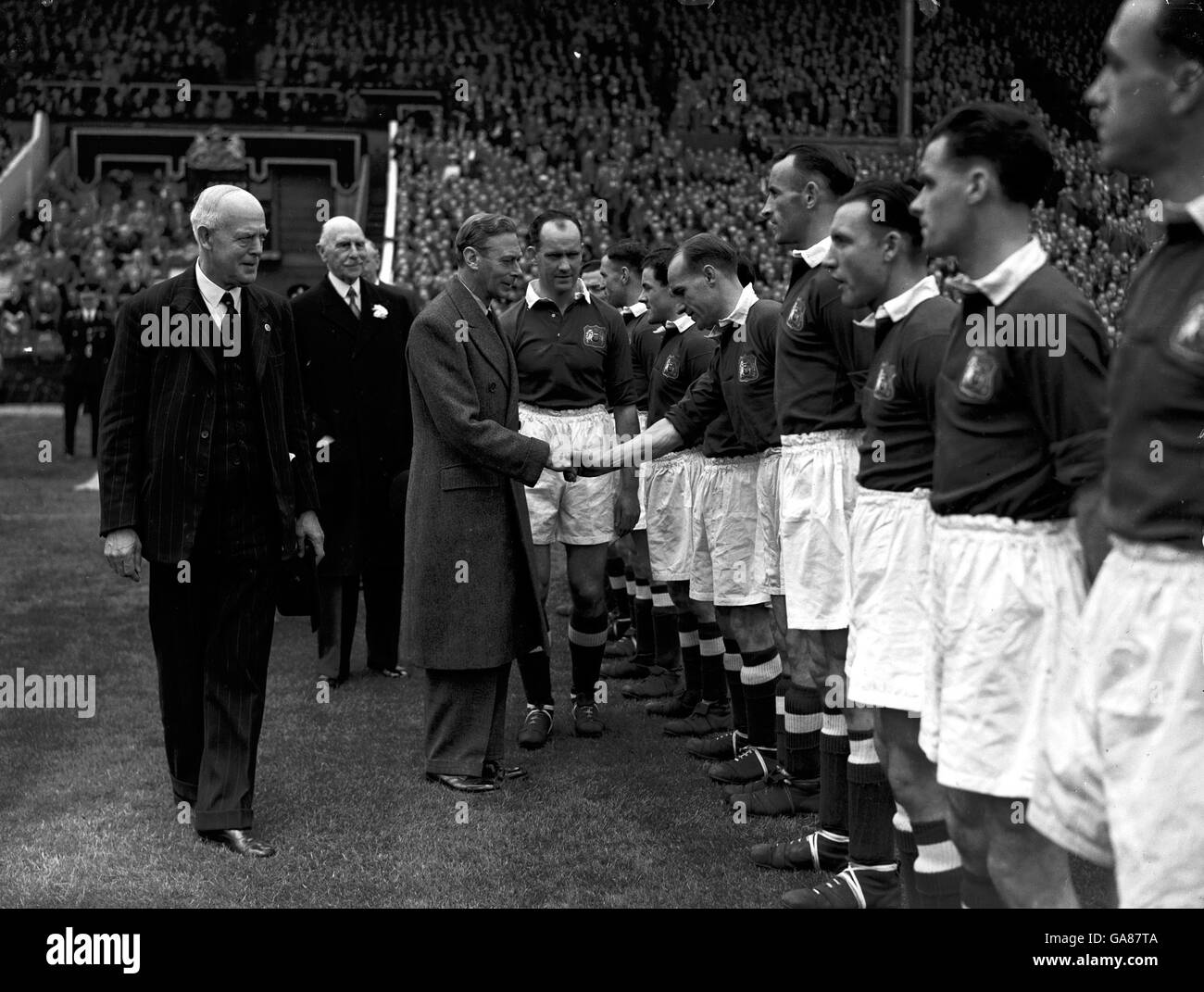 HM King George VI shakes hands with some of the Manchester United team ...