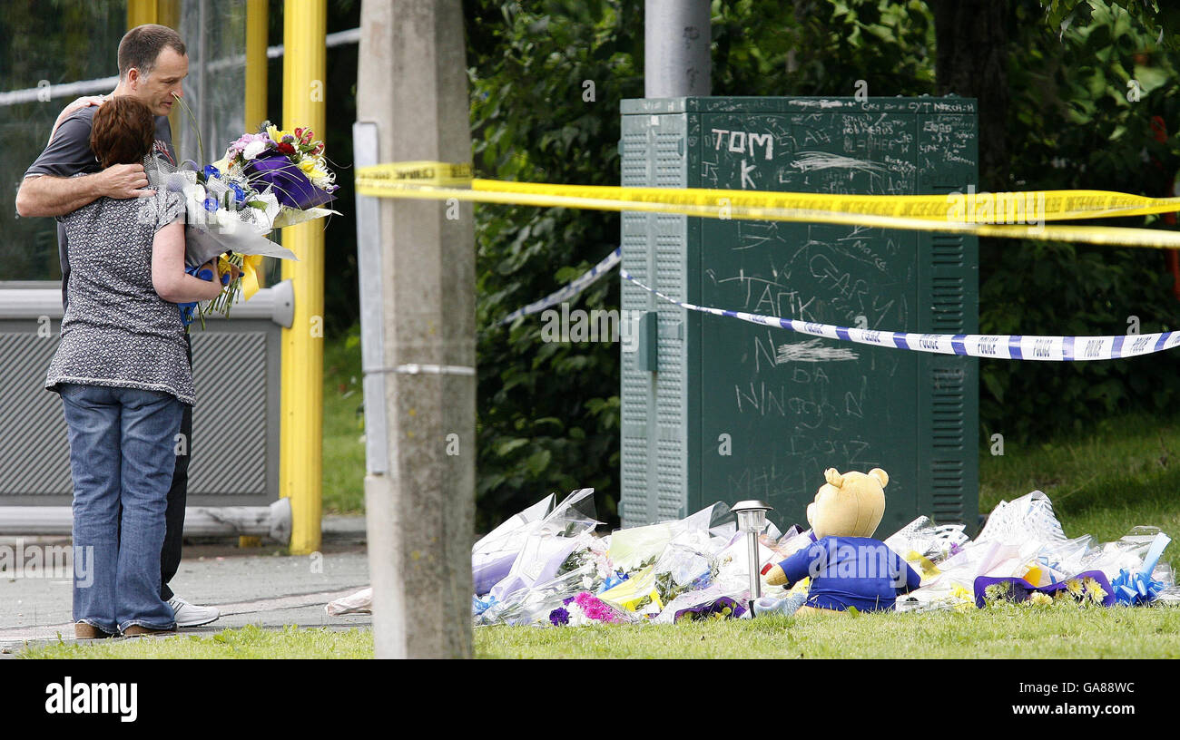 Melanie and Stephen Jones bring flowers to the scene of the shooting of ...