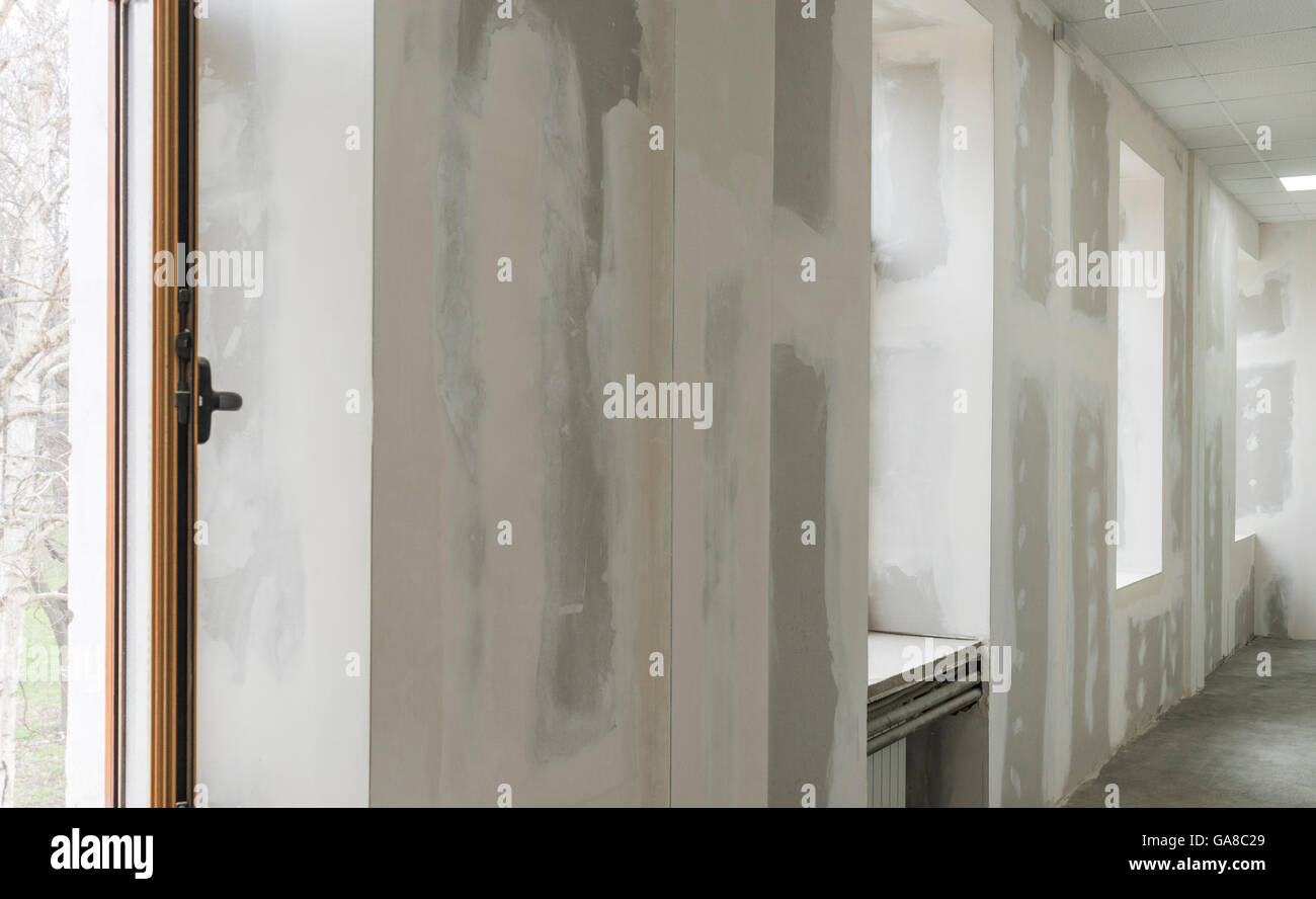 Unfinished walls with windows in apartment Stock Photo - Alamy