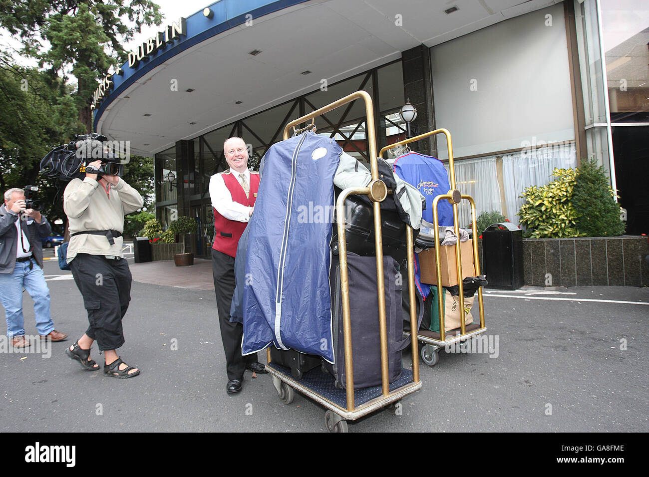 Jurys Hotel porter Paul Doogan loads some of the last guests' baggage ...