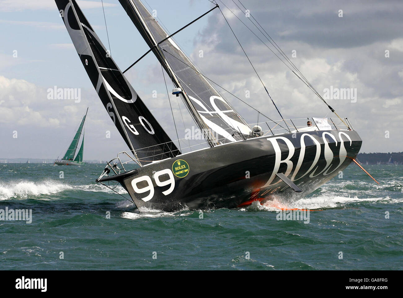 Alex Thomson's Open 60 yacht Hugo Boss leads the fleet at the start of ...