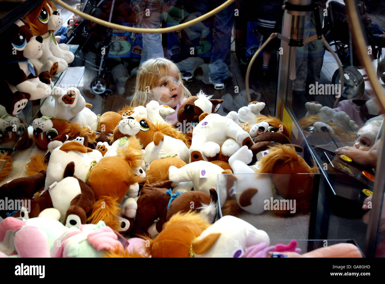 A young girl looks on at the prizes on offer in an amusement arcade at ...