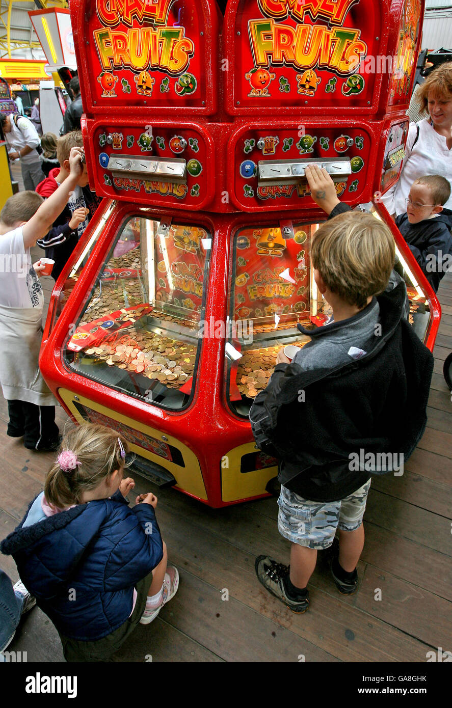 Children play in the seaside amusement arcades as bad weather draws ...