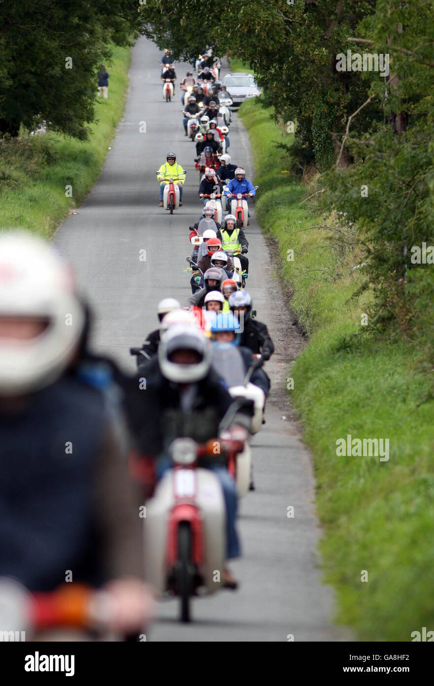 Owners of Honda step-thru 50, 70 and 90cc mopeds take part in a world ...