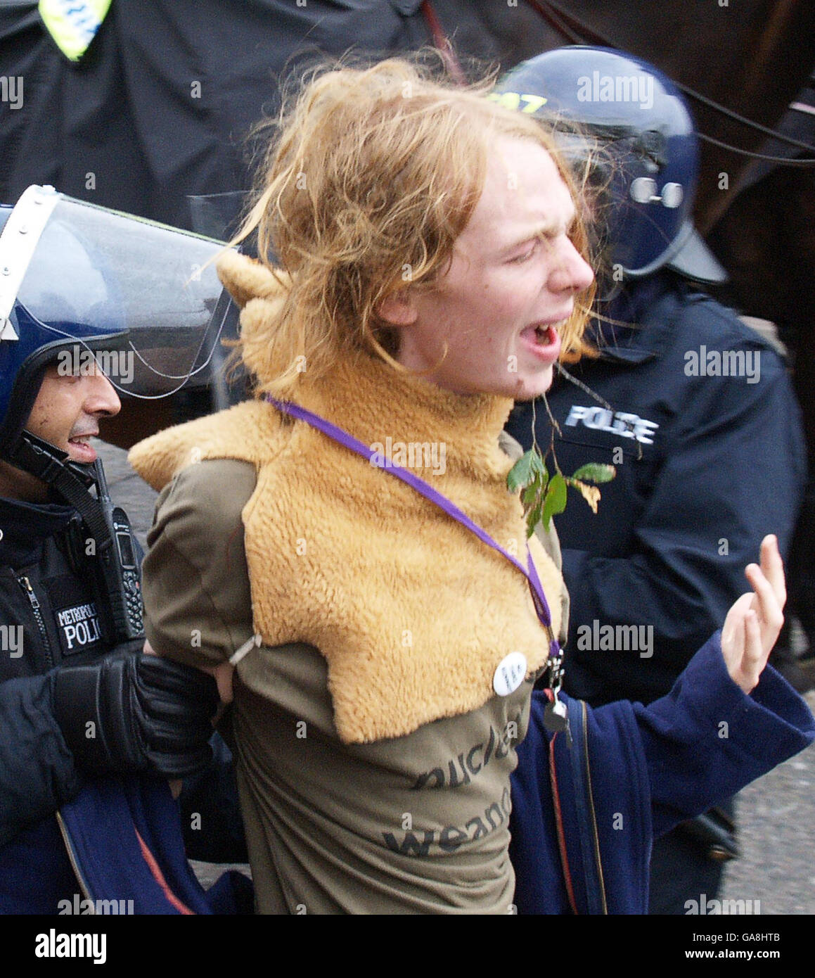 A climate change demonstrater is removed from a road by riot police ...