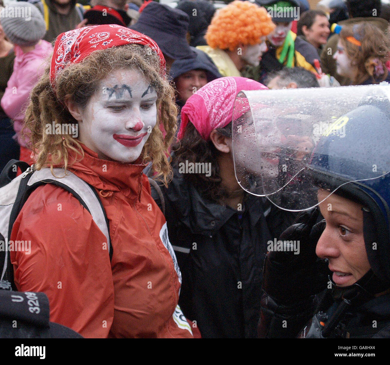 A riot policewoman and a painted climate change demonstrater outside ...