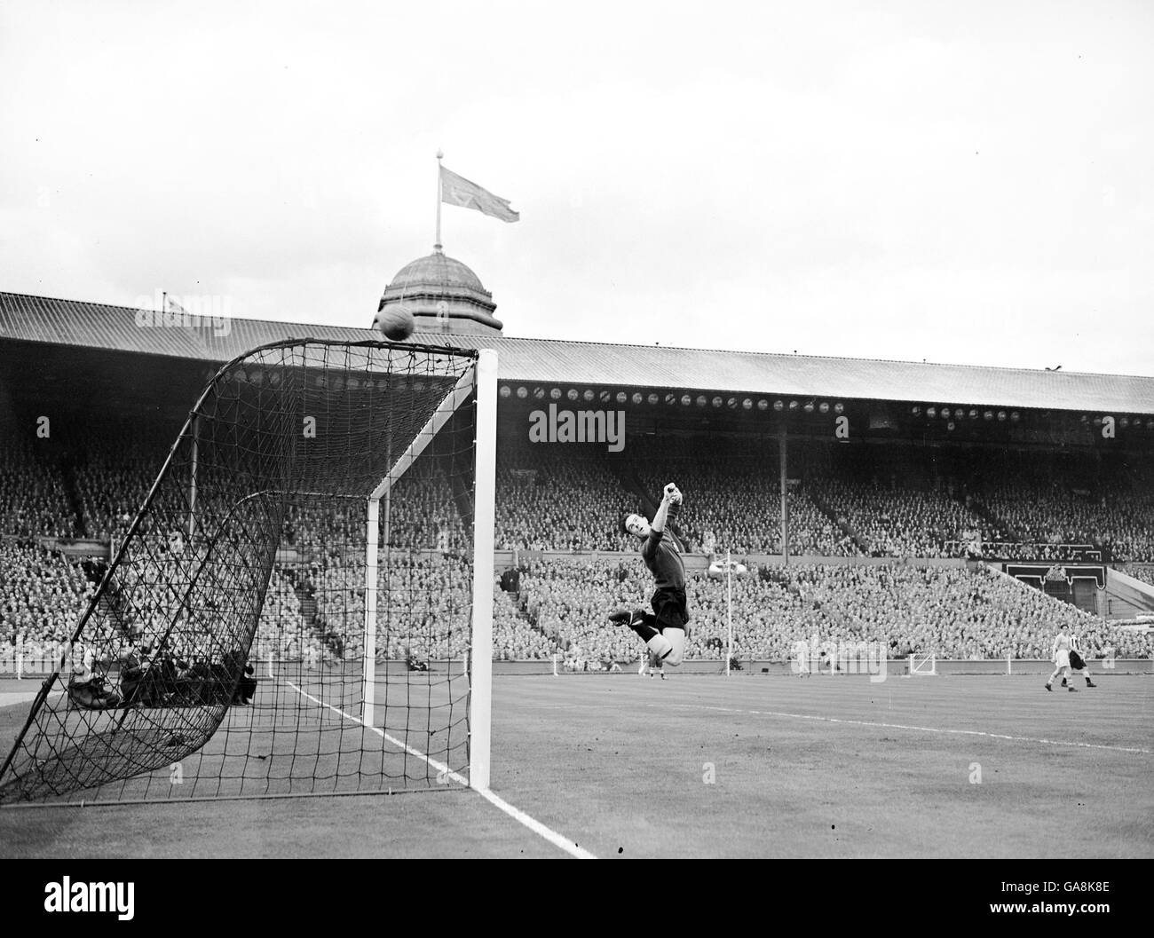Newcastle goalkeeper, Ron Simpson dives for a high ball from Man City's ...