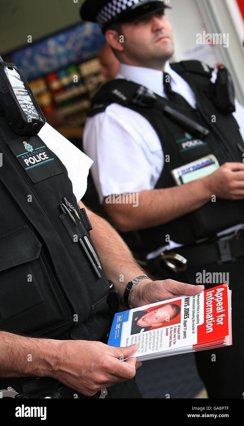 Merseyside Police officers hand out leaflets outside a Tesco store in ...