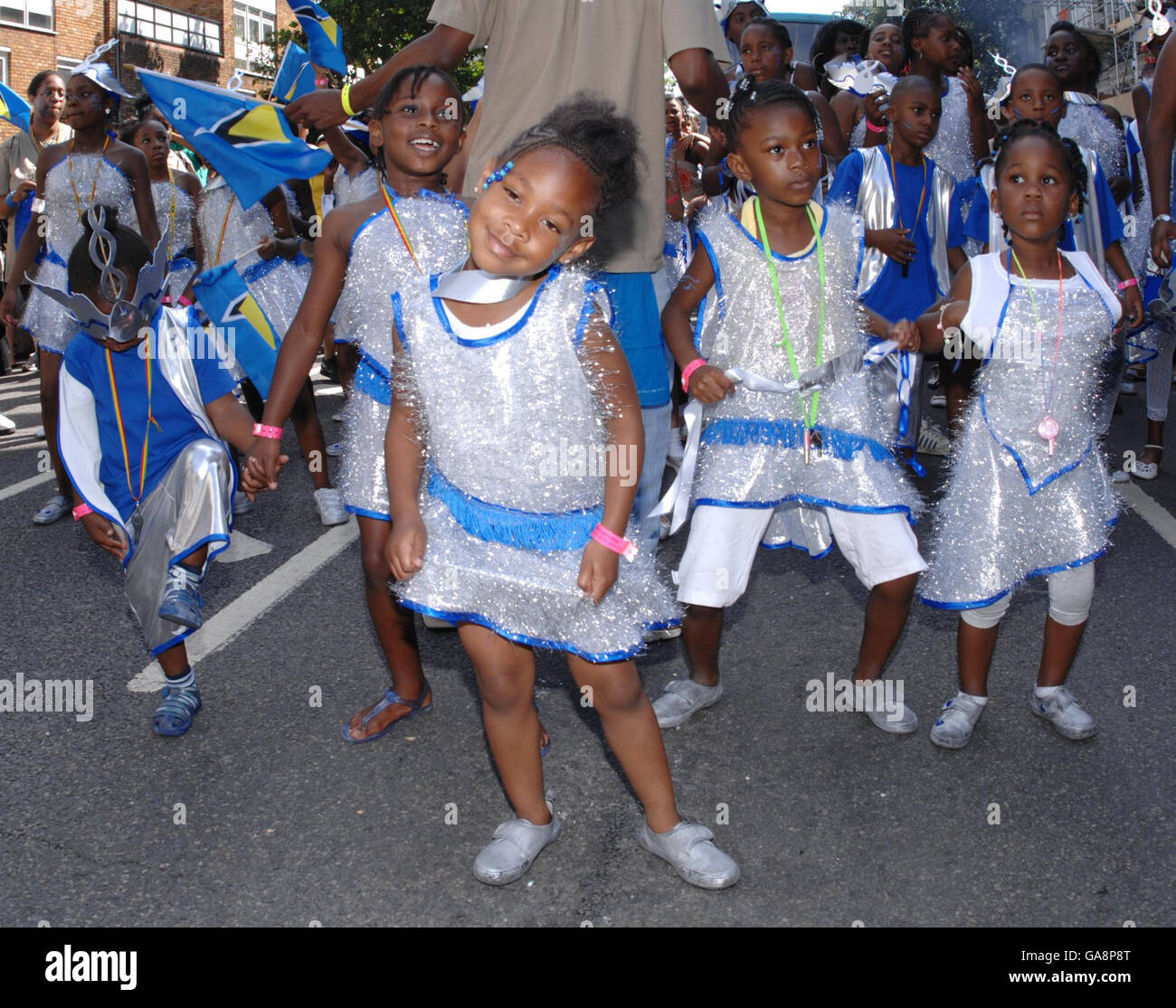 Carnival revellers join the procession of junior entrants in the ...