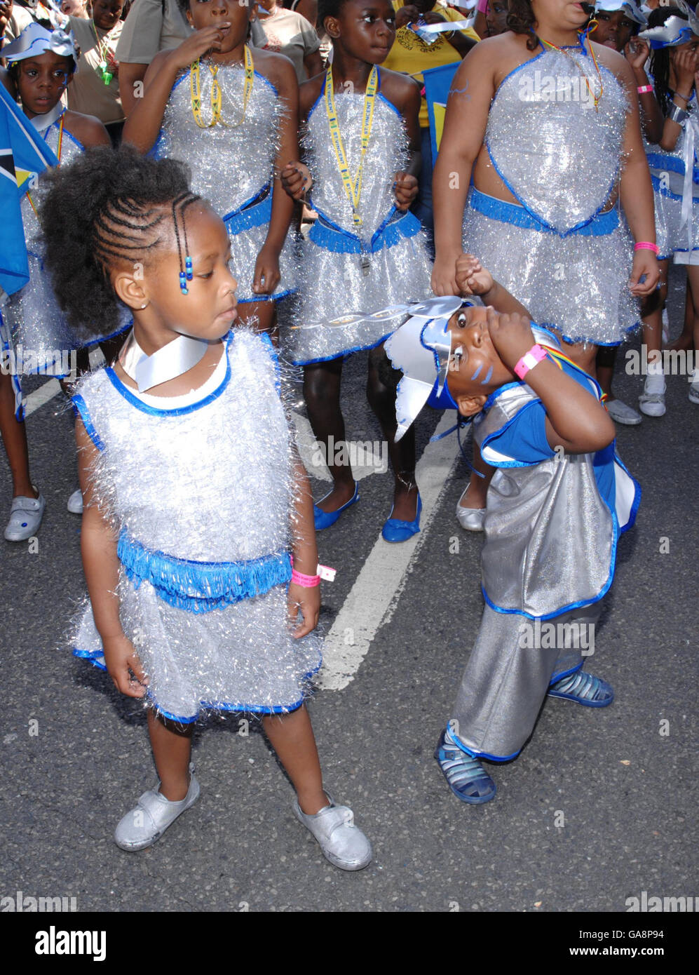 Carnival revellers join the procession of junior entrants in the ...
