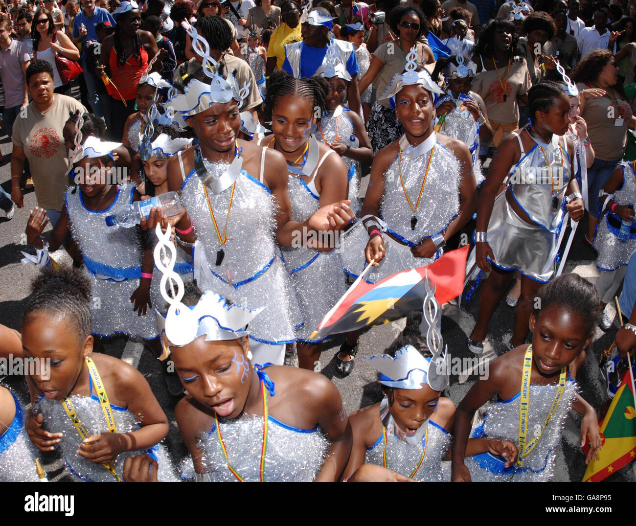 Carnival revellers join the procession of junior entrants in the ...