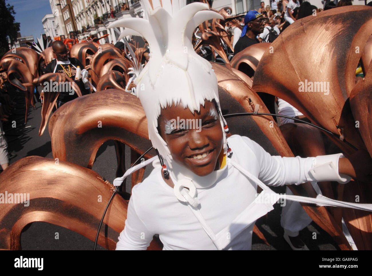 Carnival revellers join the procession of junior entrants in the ...