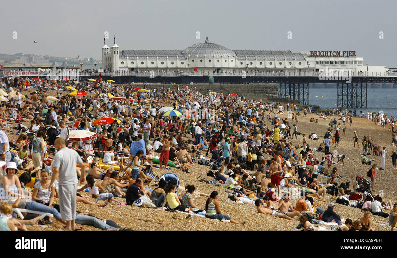 People enjoying the sunny weather on brighton beach in sussex hi-res ...