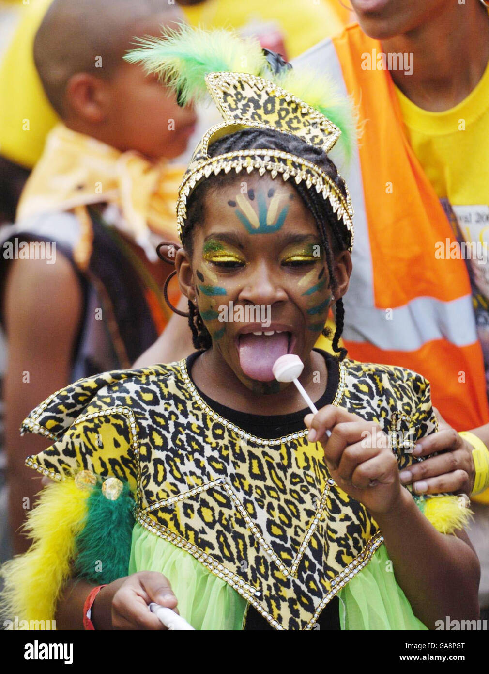 Notting Hill carnival. Carnival revellers join the procession of junior ...