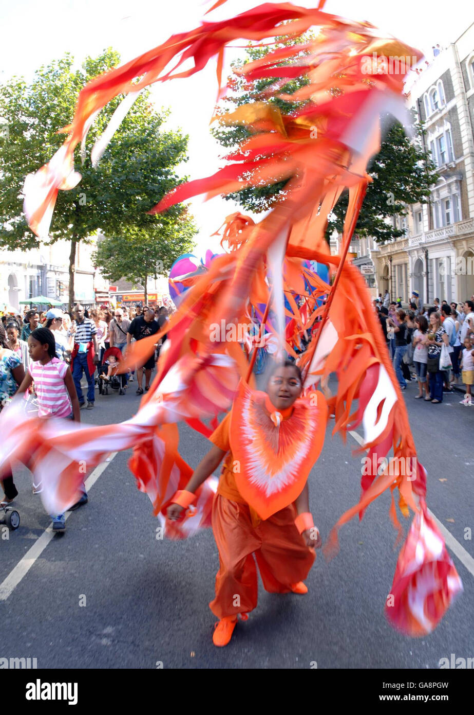 Carnival revellers join the procession of junior entrants in the ...