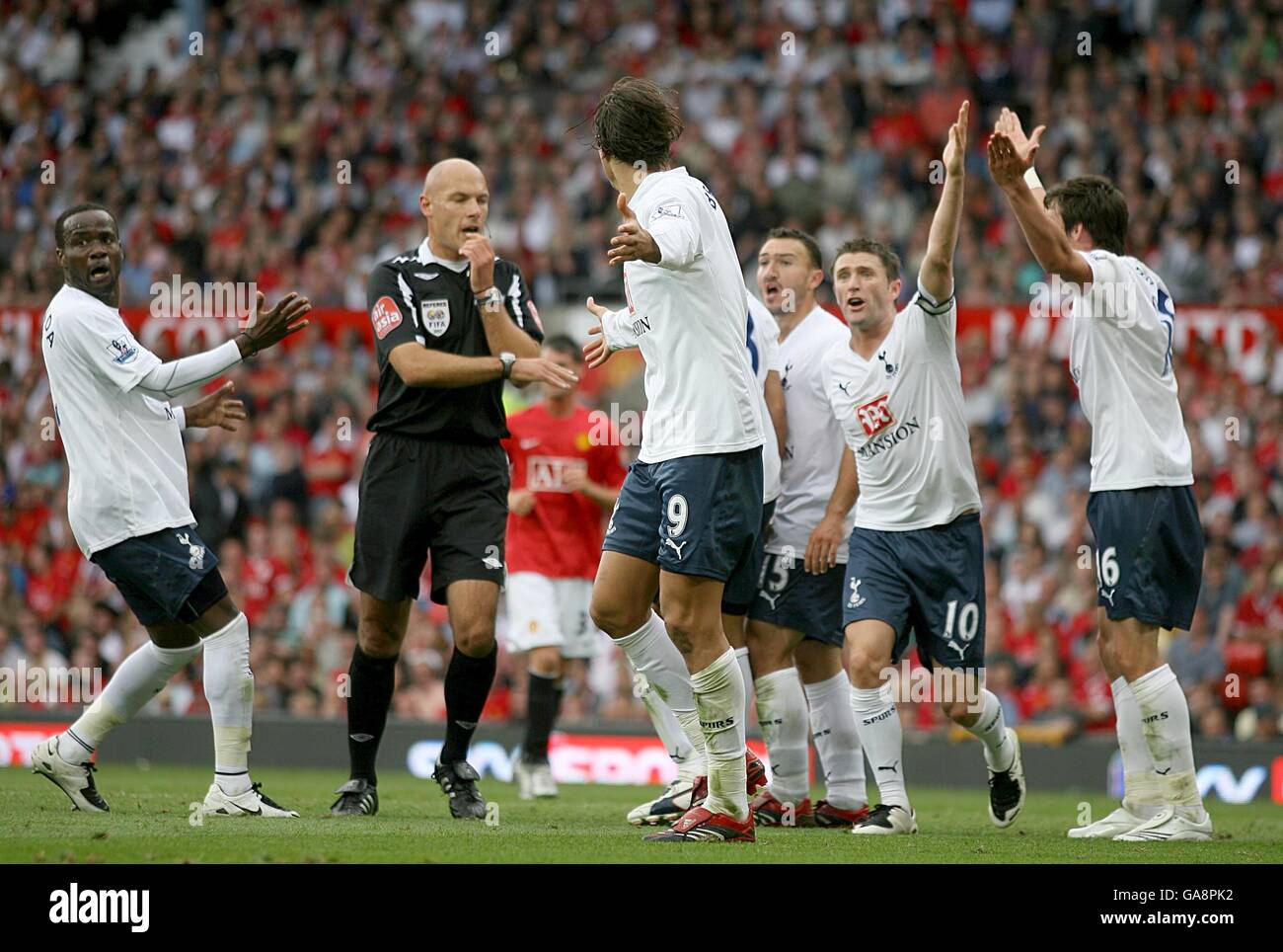 Tottenham Hotspurs players surround referee Howard Webb as they appeal ...