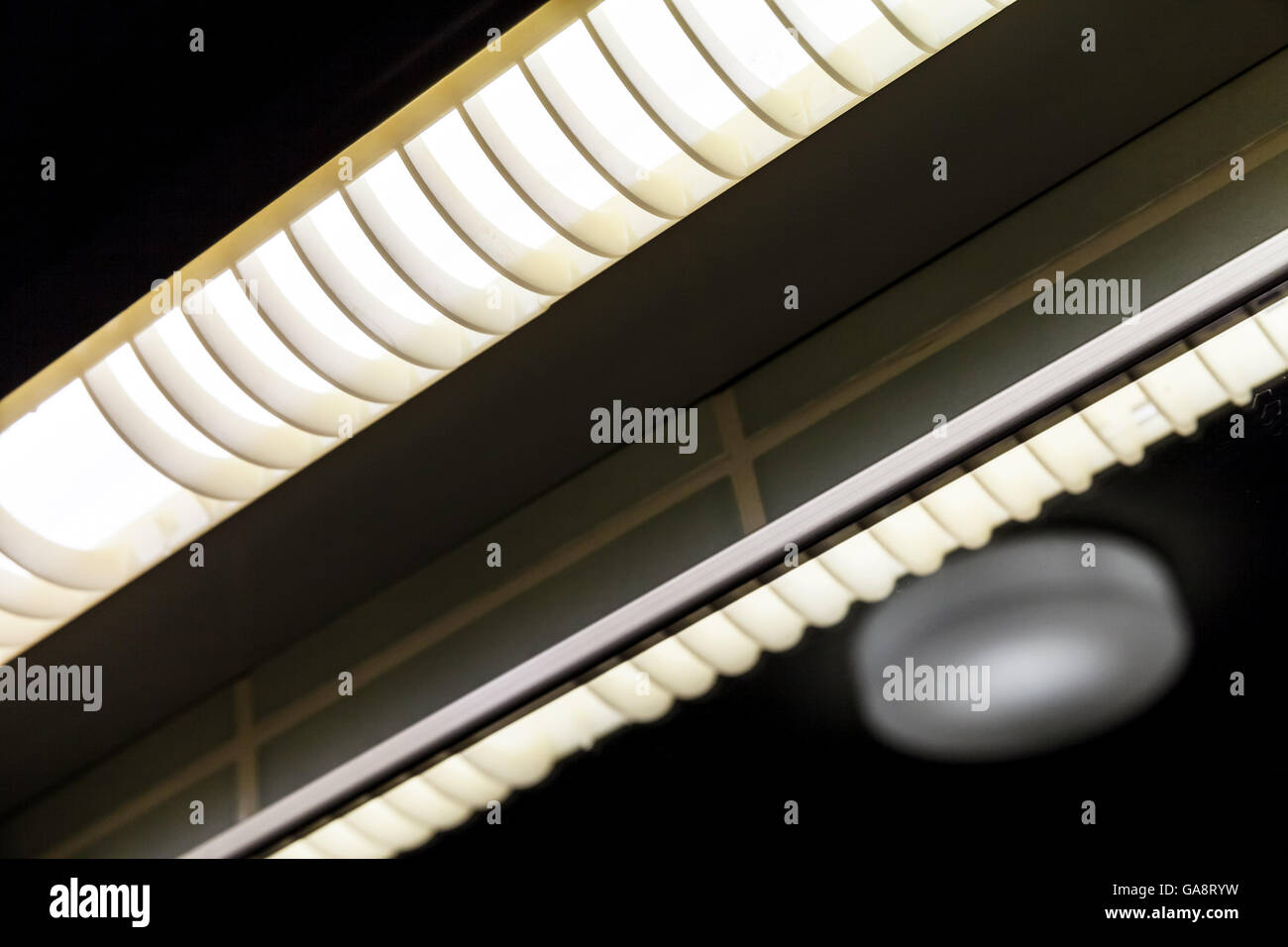 Neon lamps glowing over dark ceiling background Stock Photo - Alamy