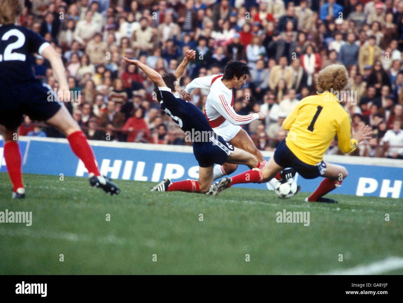 Scotland's Stuart Kennedy (l) and goalkeeper Alan Rough (r) try to halt ...