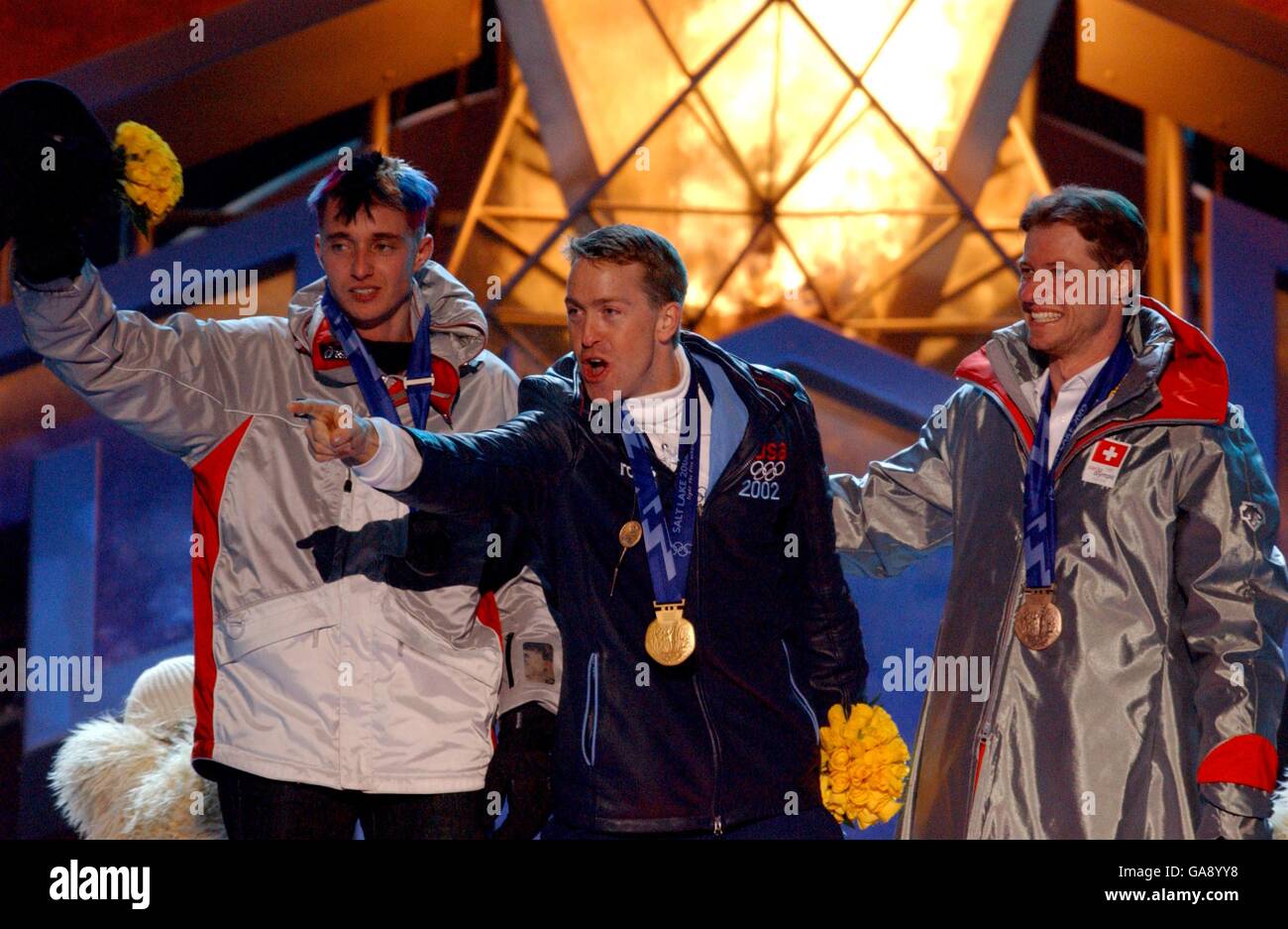 USA's Jim Shea (c) celebrates winning the gold medal with Austria's ...