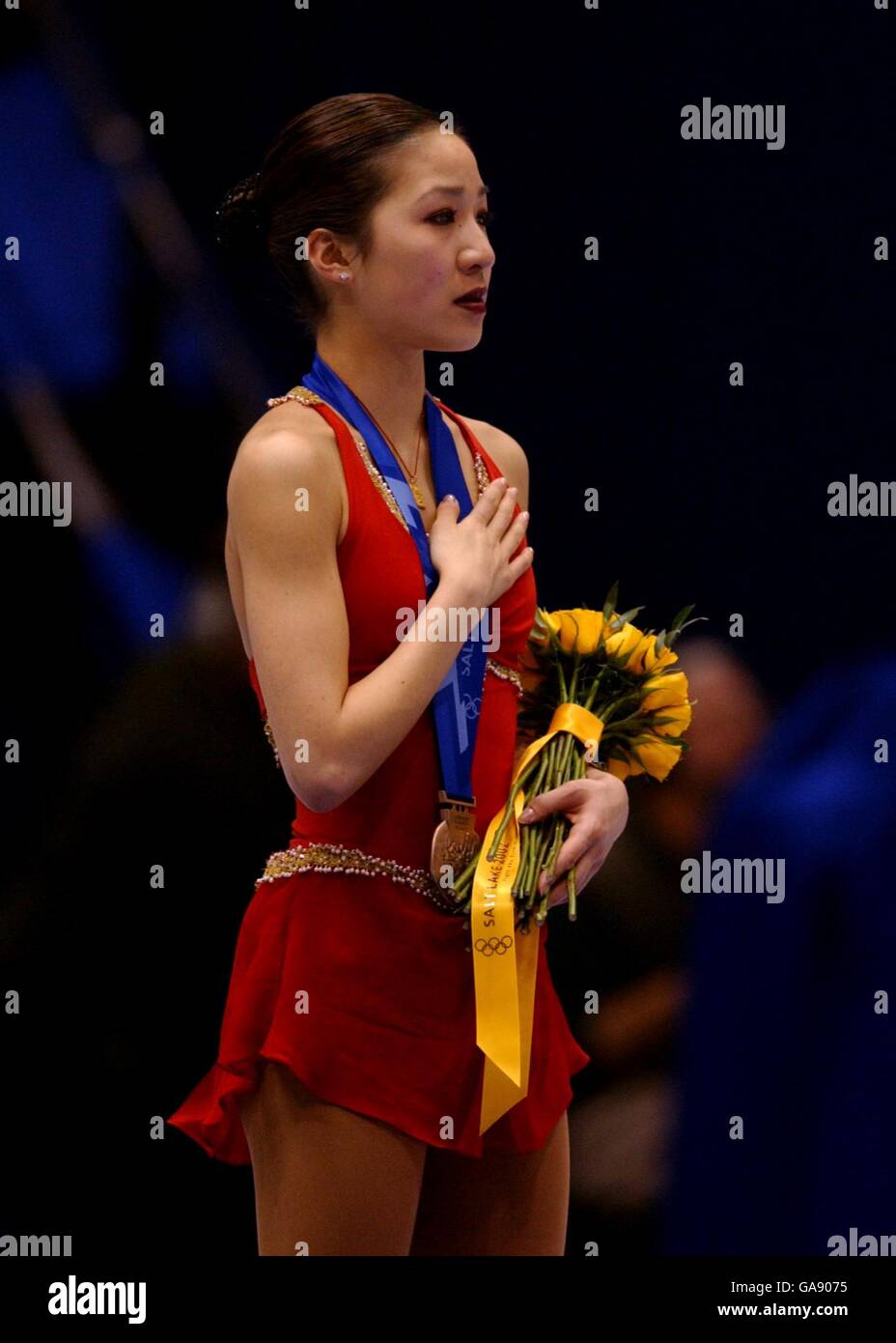 A dejected USA's Michelle Kwan stand's on the podium with her bronze ...
