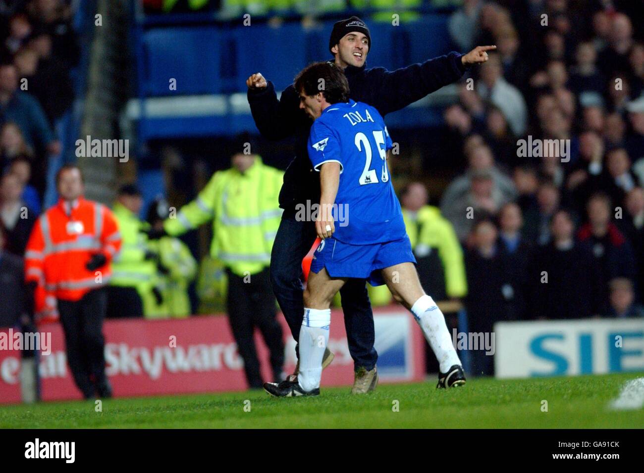 Chelsea's Gianfranco Zola pushes an angry Chelsea fan off the pitch ...