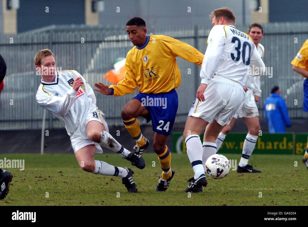Mansfield Town's Lee Williamson tackles by Oxford United's Paul Tait ...
