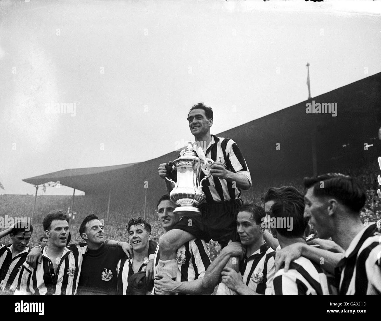Newcastle United captain Joe Harvey shows off the FA Cup as his ...