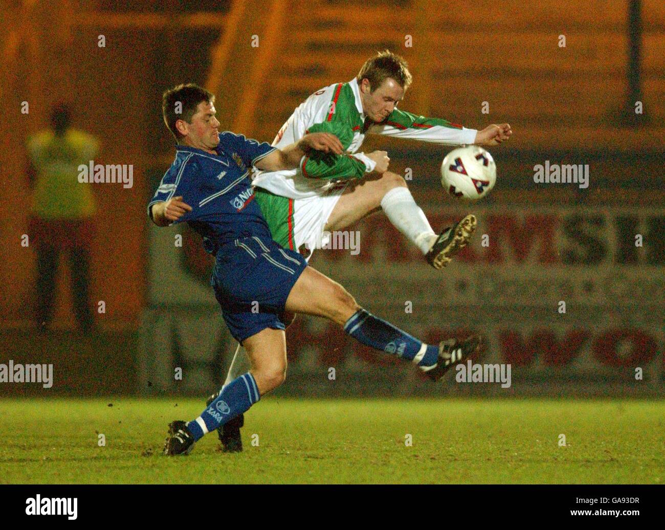 Halifax Town's Craig Midgley loses out to a clearance by Carlisle ...