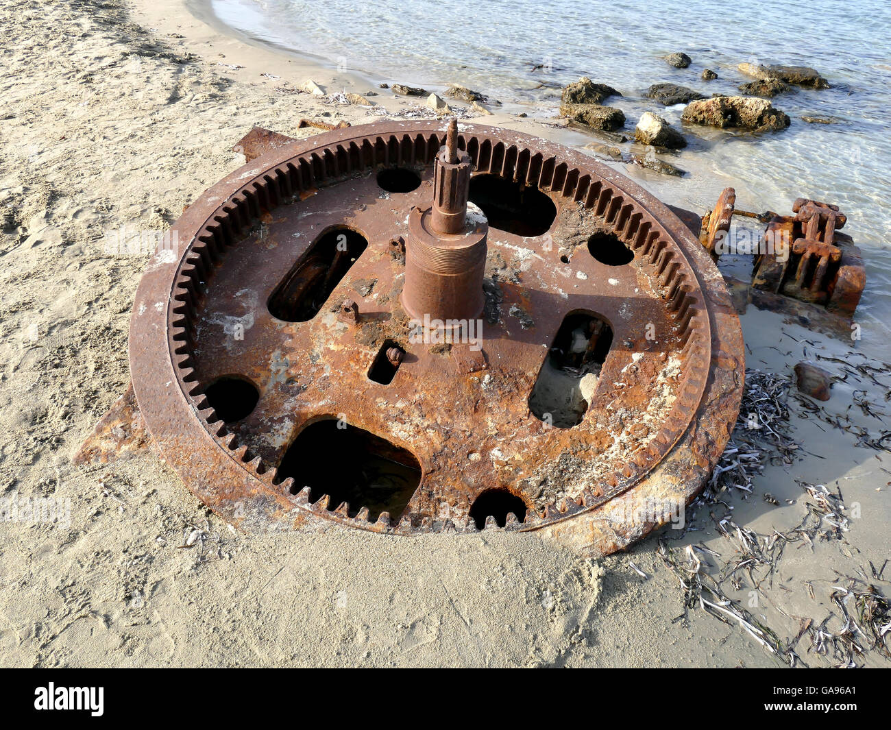 Rusted cogwheel of old ship stranded on beach Stock Photo - Alamy