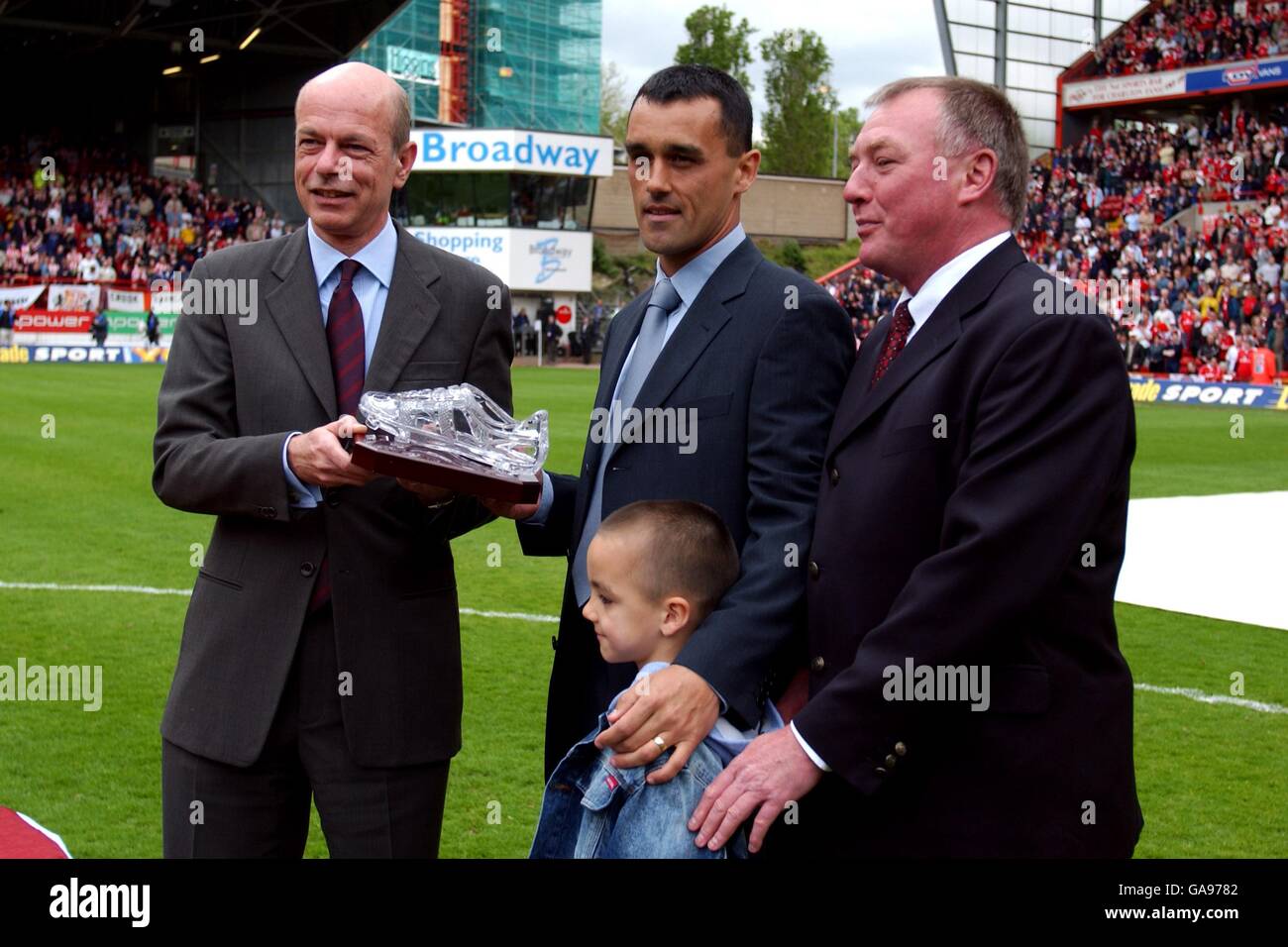 Clive Mendonca is presented with a trophy to acknowledge his ...