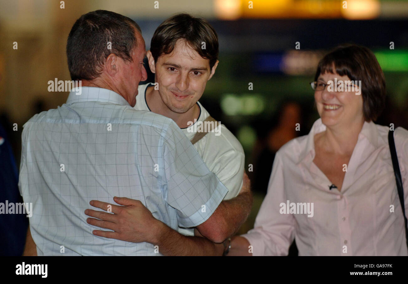 Briton Jody Aggett (centre) is greeted by parents Tony and Lorna at ...