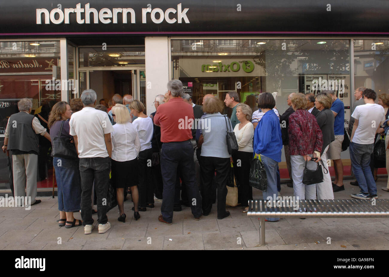 Customers queue outside a branch of Northern Rock in Kingston Upon ...