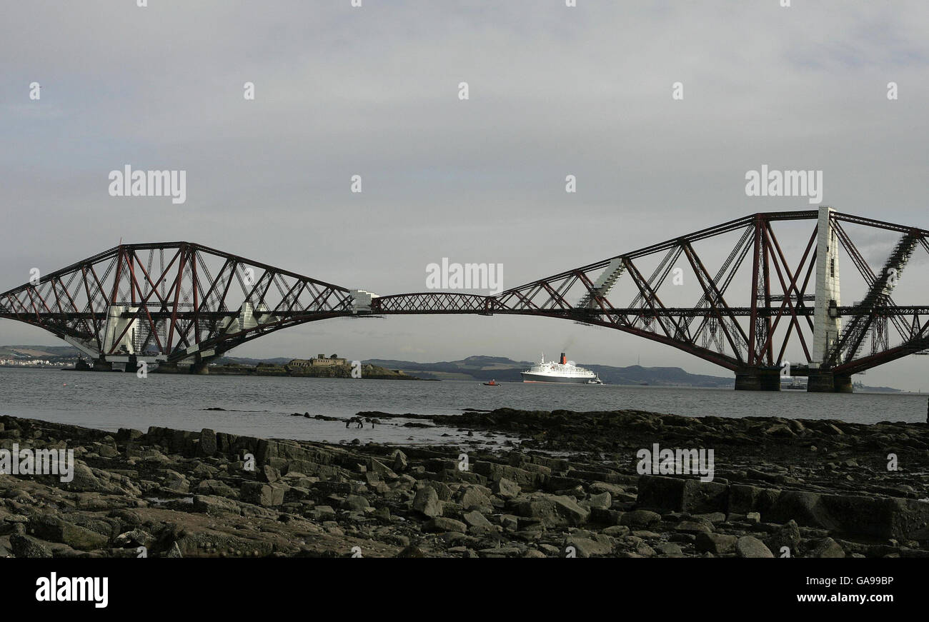 The QE2 moores in the River Forth beside the Forth Rail Bridge during ...