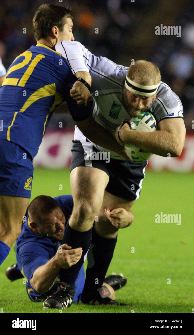 Scotland's Craig Smith holds off Romania's Ionut Tofan during the IRB ...