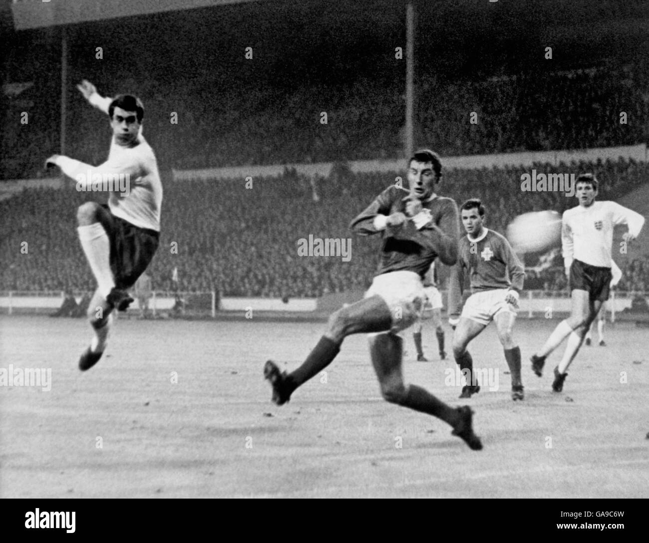 England's Geoff Hurst (l) smashes the ball past Northern Ireland's ...