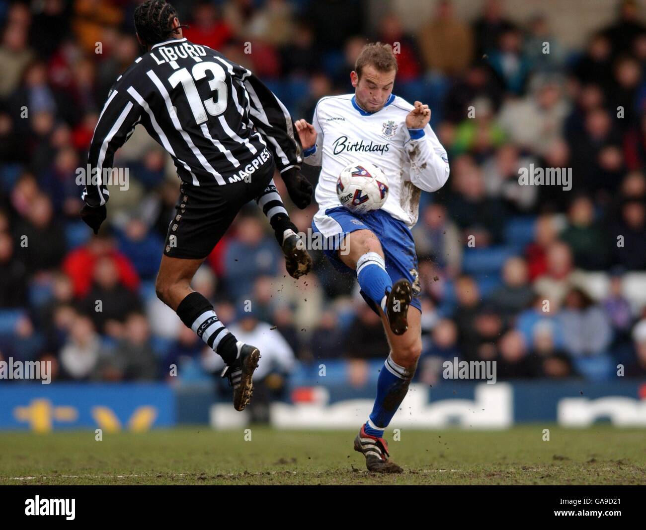 Bury's Lee Connell holds the ball from the advancing Richard Liburd of ...