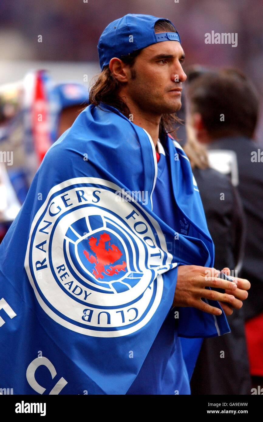 Rangers' Lorenzo Amoruso draped in a flag and holding his winners medal ...