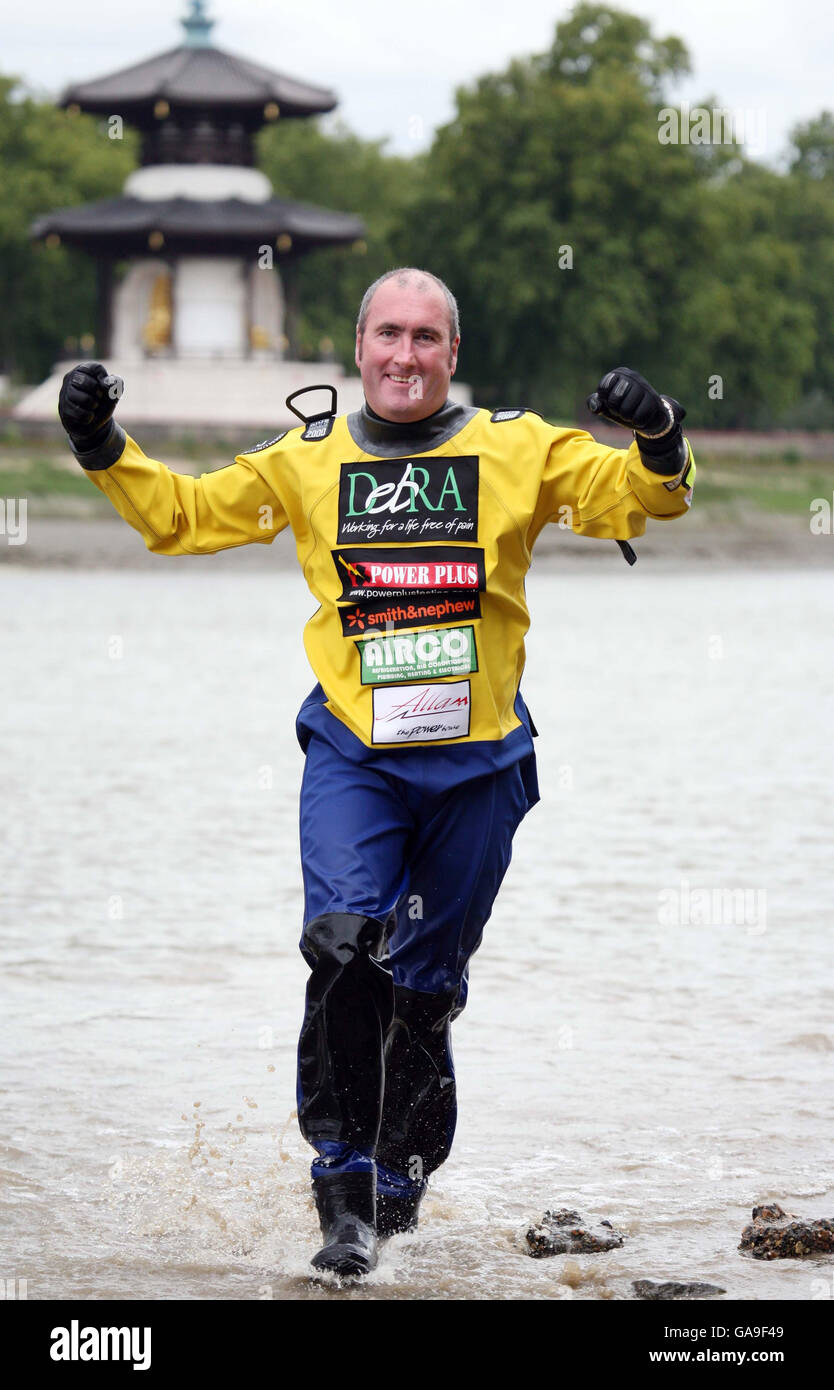 Graham Boanas, 44, from Hull, cheers after crossing the River Thames ...