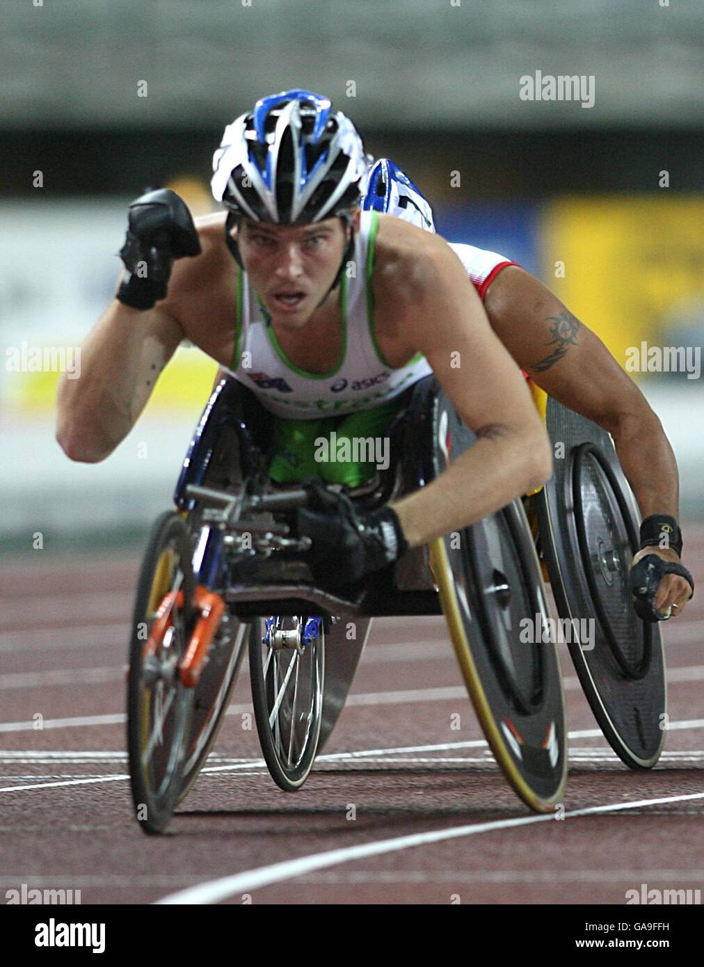 Australia's Kurt Fearnley celebrates as he crosses the line in first ...