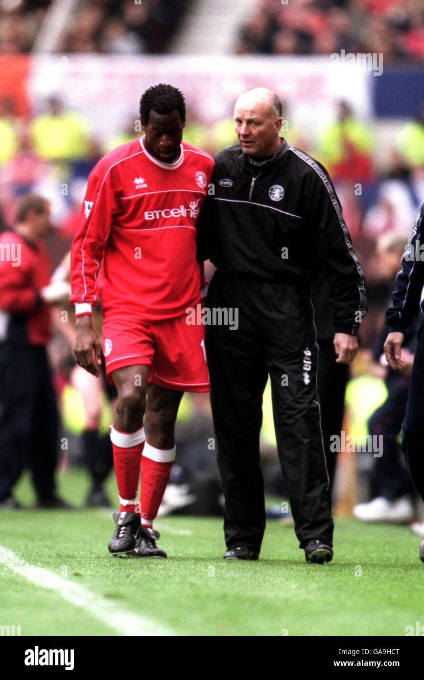Middlesbrough's Ugo Ehiogu is helped from the field following an injury ...