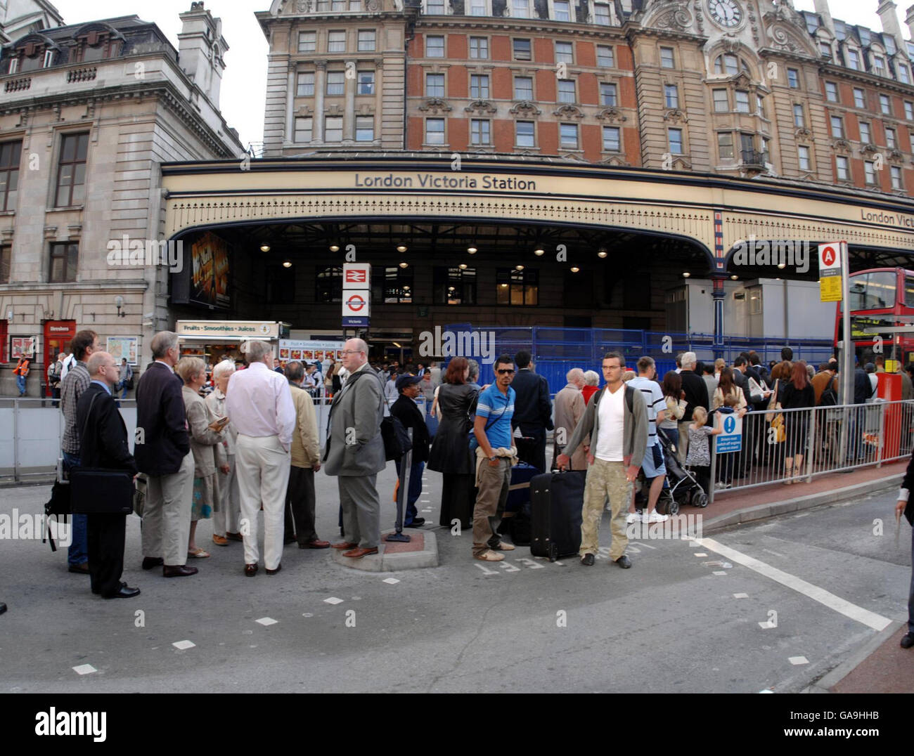 Commuters wait for a bus outside Victoria station, London, as thousands ...