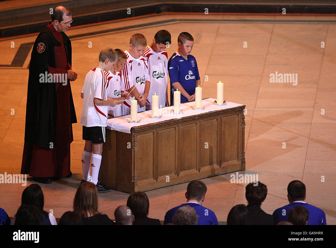 Friends of Rhys Jones light candles during the 11-year-old's funeral at ...