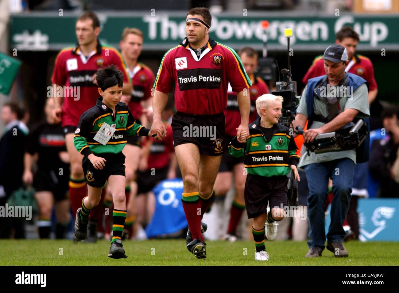 Northampton Saint's captain Budge Pountney leads his side out flanked ...