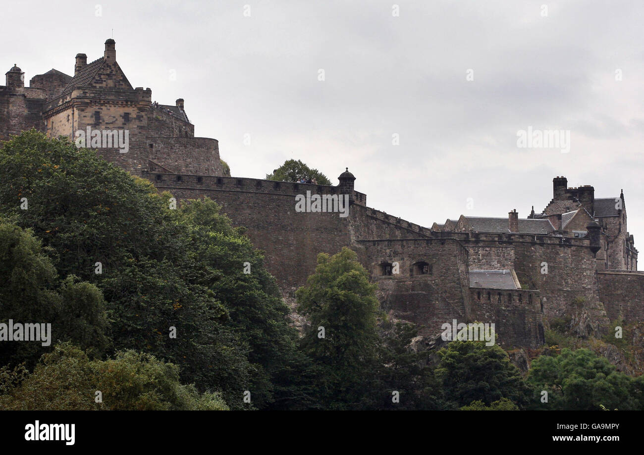 Workmen hang from ropes as they scale the rock walls of Edinburgh ...
