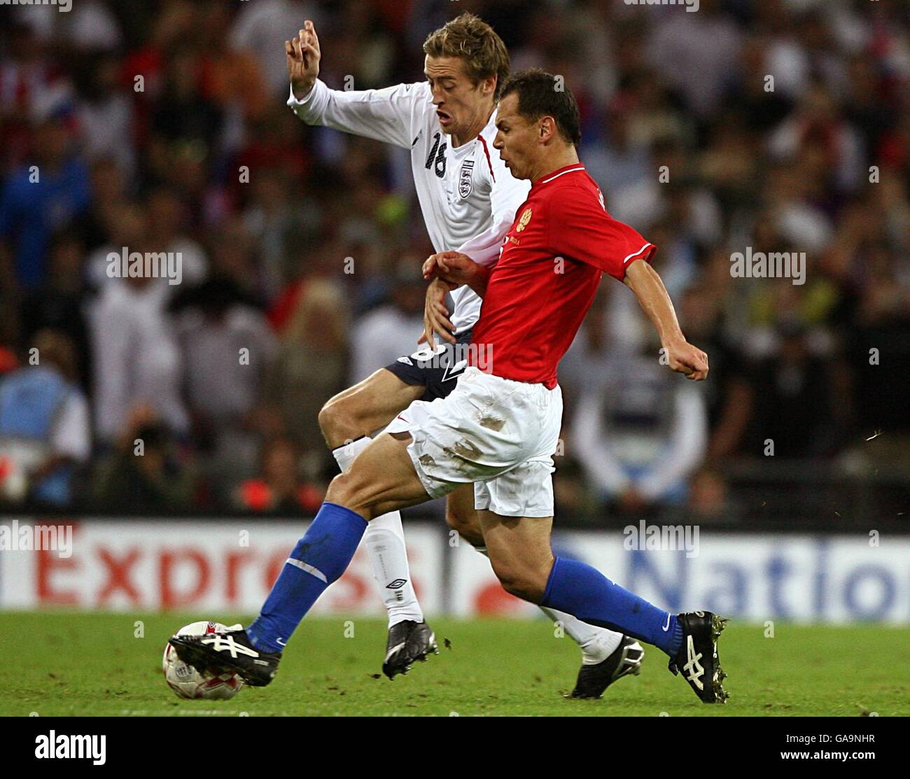 Russia's Sergei Ignashevich (right) and England's Peter Crouch battle ...