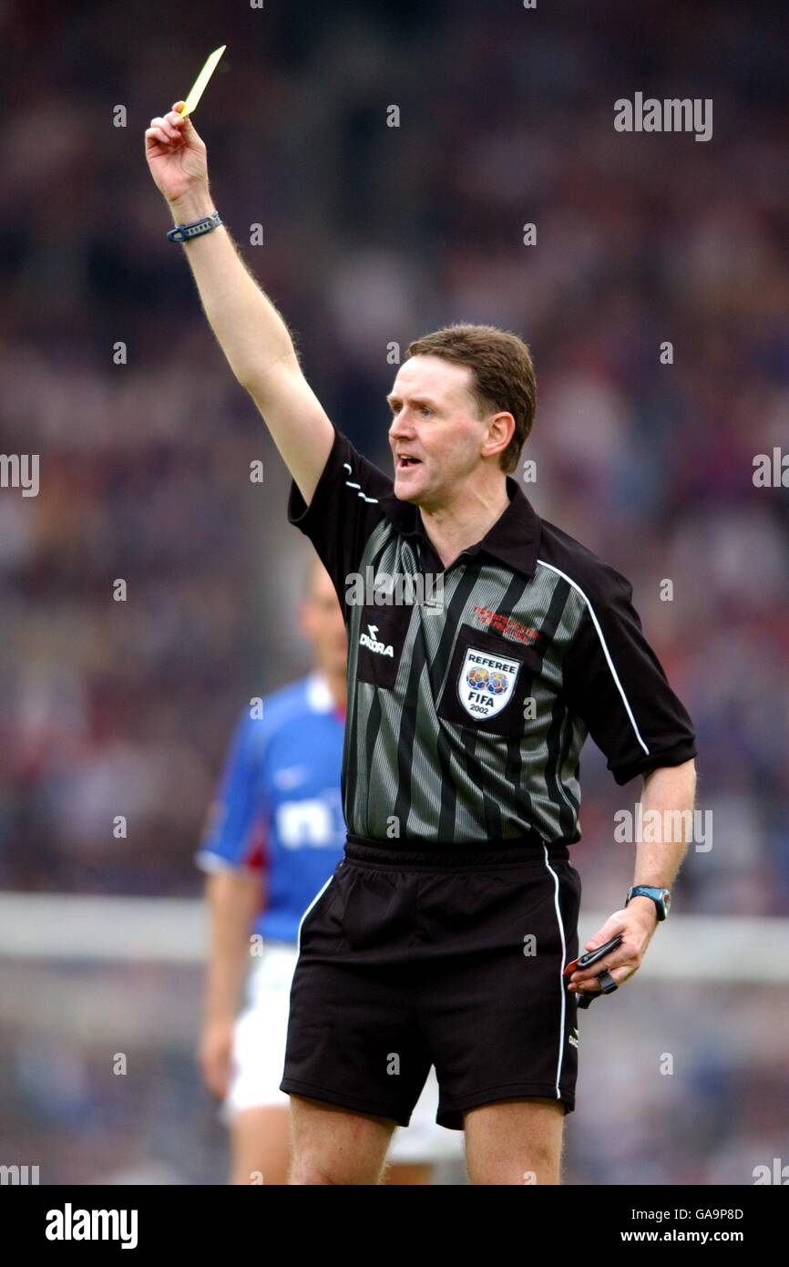 Referee hugh dallas shows a yellow card hi-res stock photography and ...