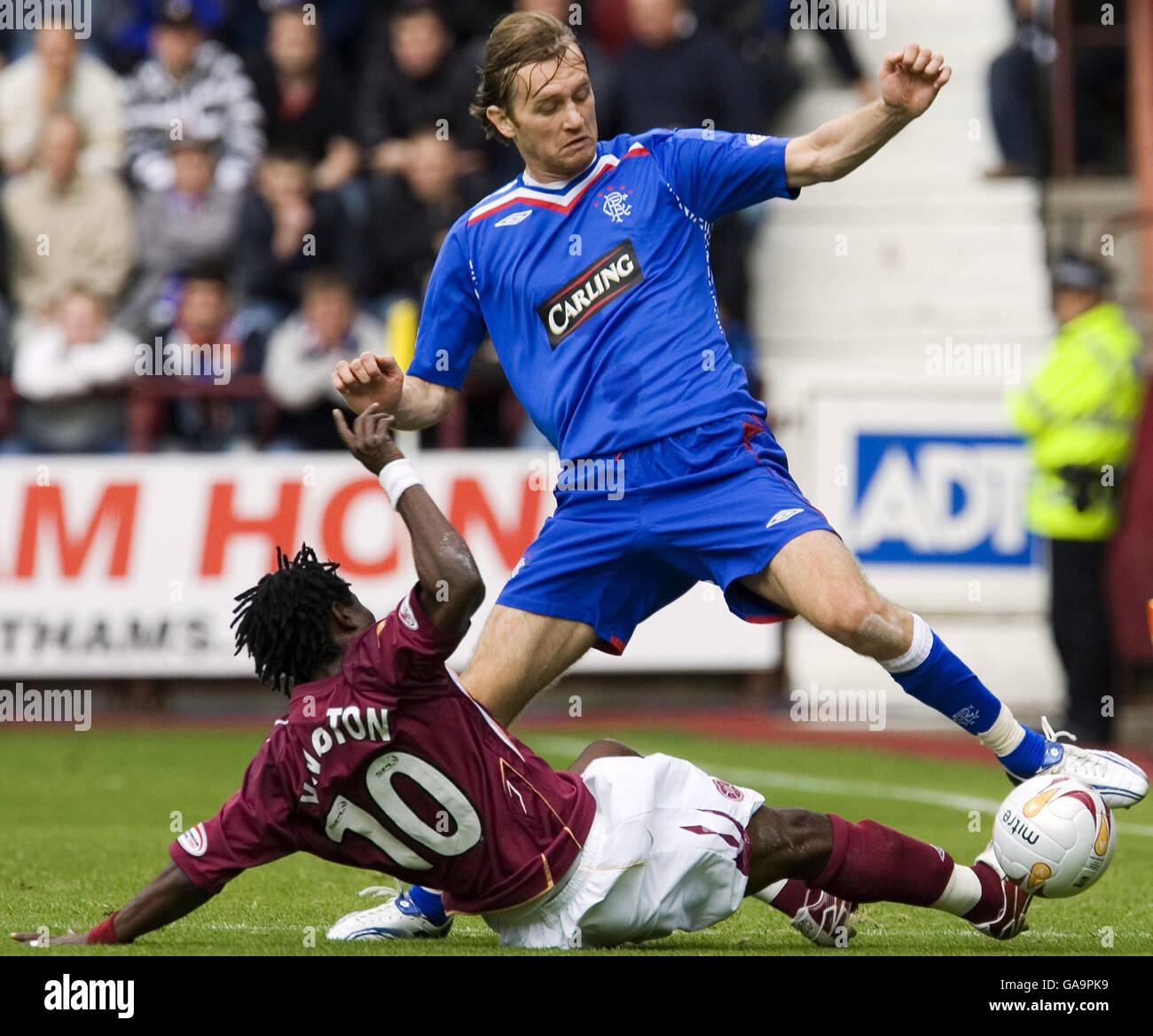 Rangers' Sasa Papac (top) is tackled by Hearts' Laryea Kingston during ...