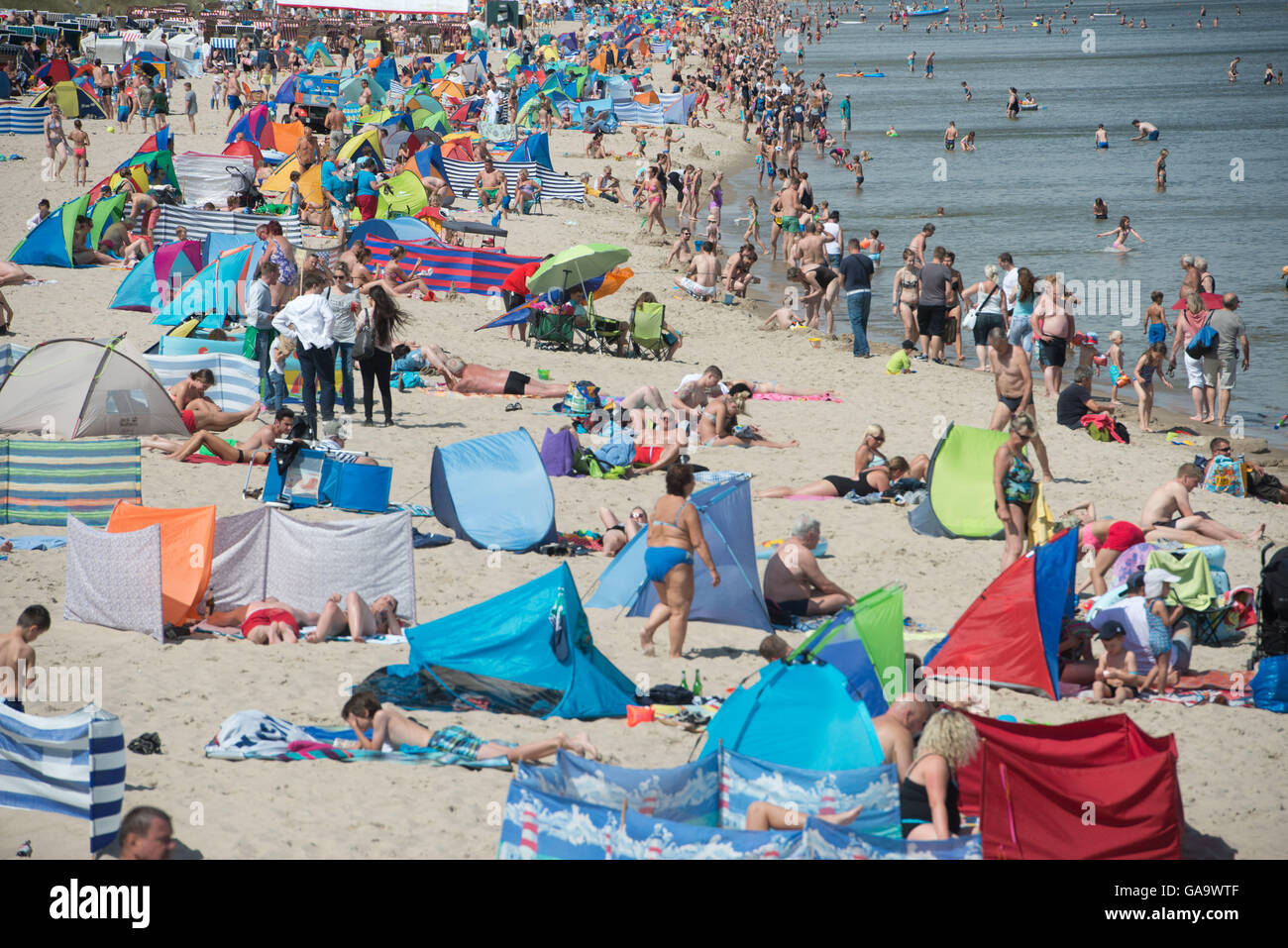 View of the crowded beach during warm weather at the Baltic Sea beach ...