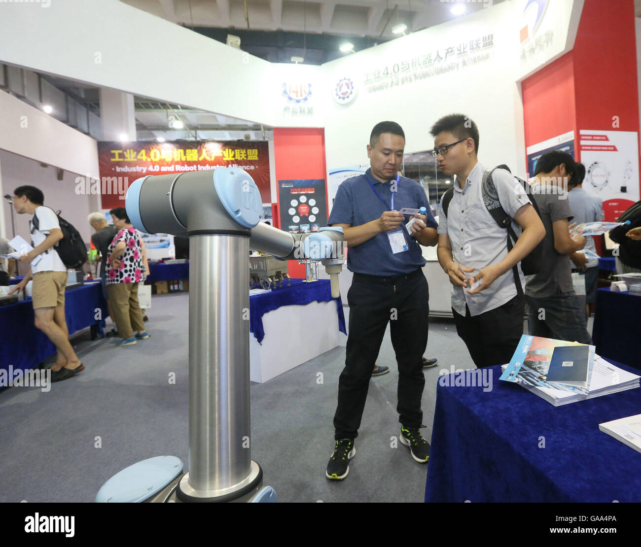 Beijing, China. 5th Aug, 2016. People watch a robot during the China (Beijing) International ...