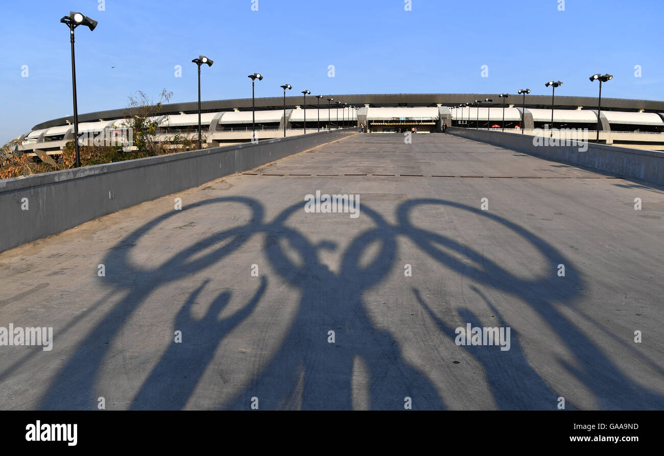 People cast shadows as they gather at the Olympic Rings outside of the ...
